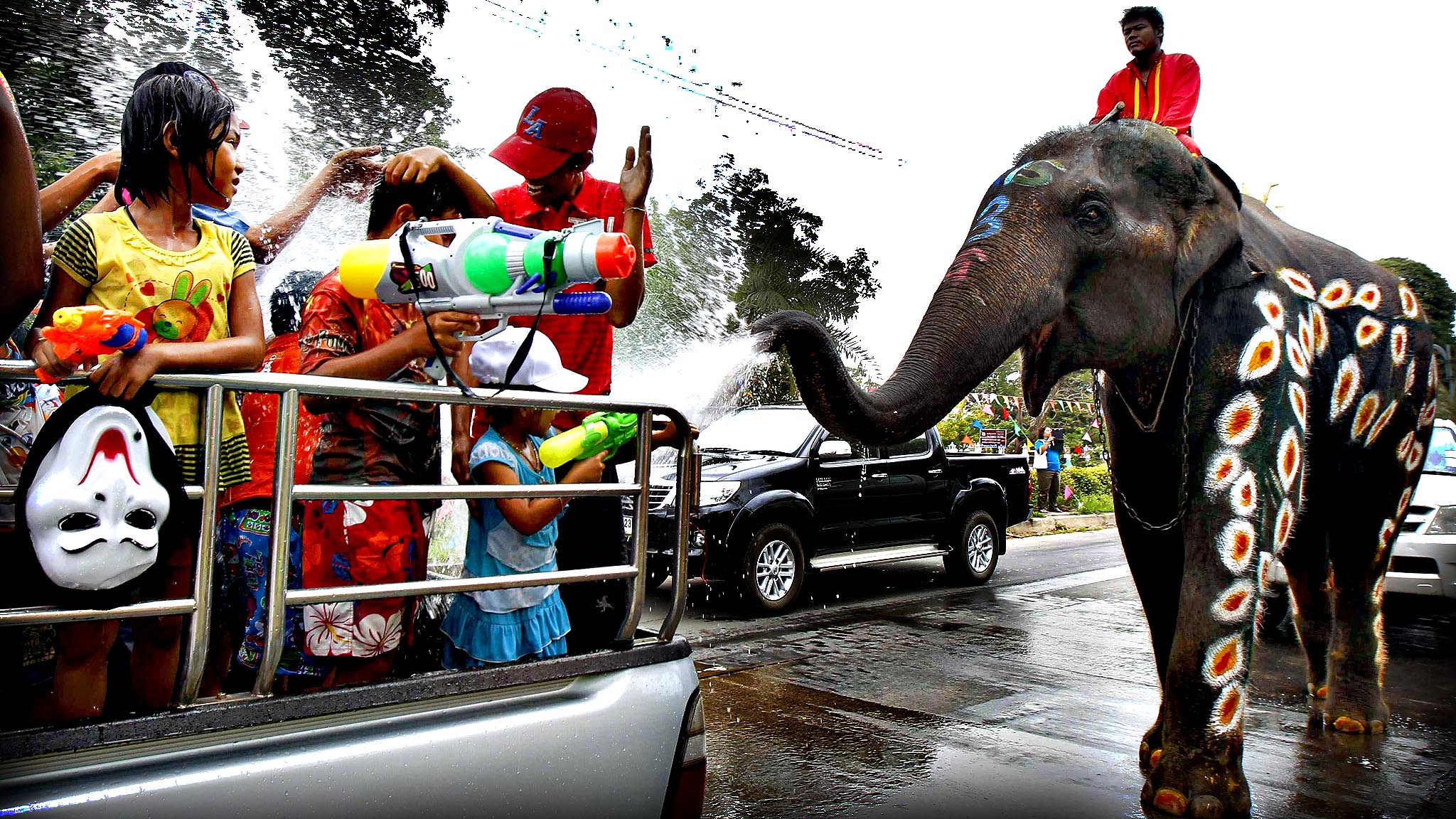 Elephants spray water at children in celebration of the Songkran - The ...